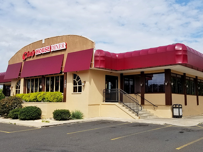 The Club House Diner's exterior is like a friendly neighbor waving you over. That red awning is basically saying "Get in here, you're hungry."