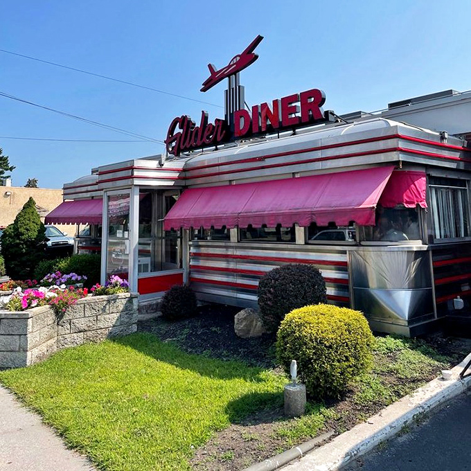 Summer at the Glider: pink awnings, manicured landscaping, and the promise of air-conditioned comfort food just steps away.