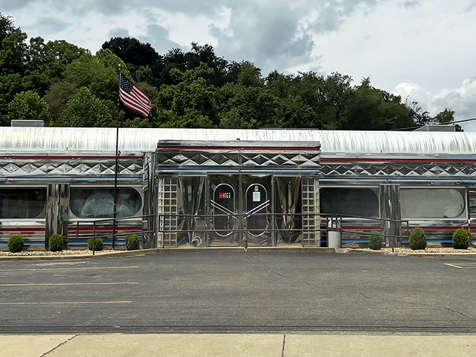 The American flag waves proudly above this temple of comfort food. Maddy's Diner 23's exterior gleams with promise, like a silver bullet of deliciousness.