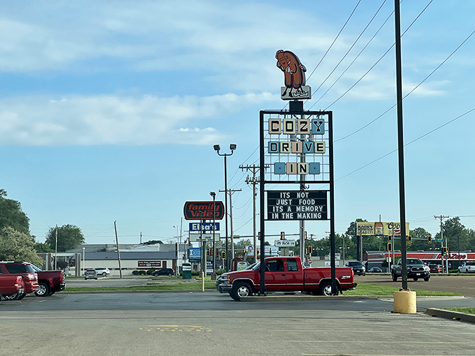 That vintage sign, featuring the iconic hugging hot dog and bun, has guided hungry travelers to deep-fried happiness for decades.