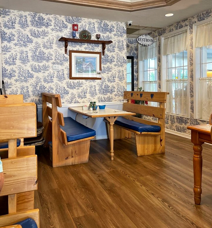 Blue toile wallpaper and wooden booths create a corner that feels like dining in your favorite aunt's country home&mdash;if your aunt were an exceptional cook.