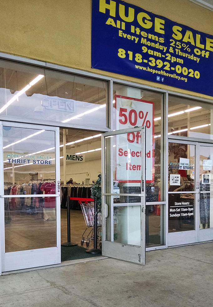The promise land entrance, where signs announce the thrill of the hunt with discounts that would make full-price retailers weep.