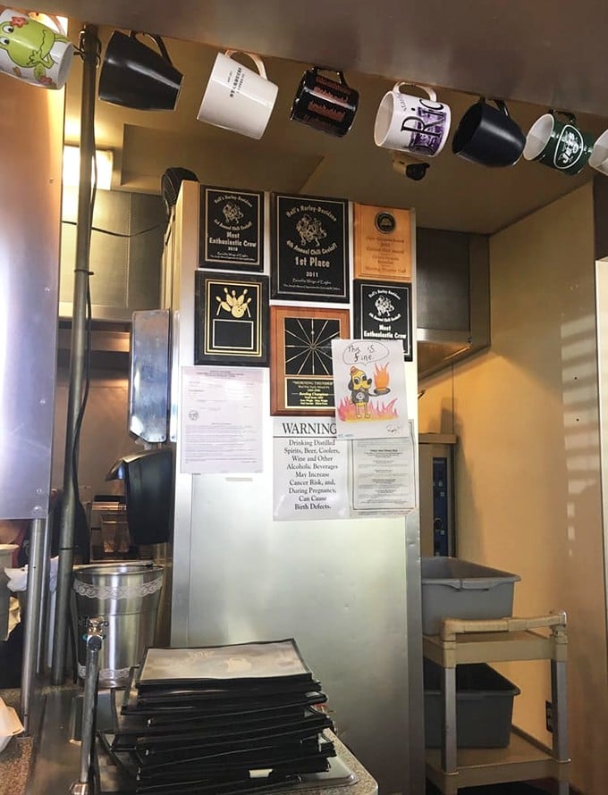 A wall of hanging mugs and achievement plaques tells the story of a beloved local institution that takes its coffee as seriously as its food.