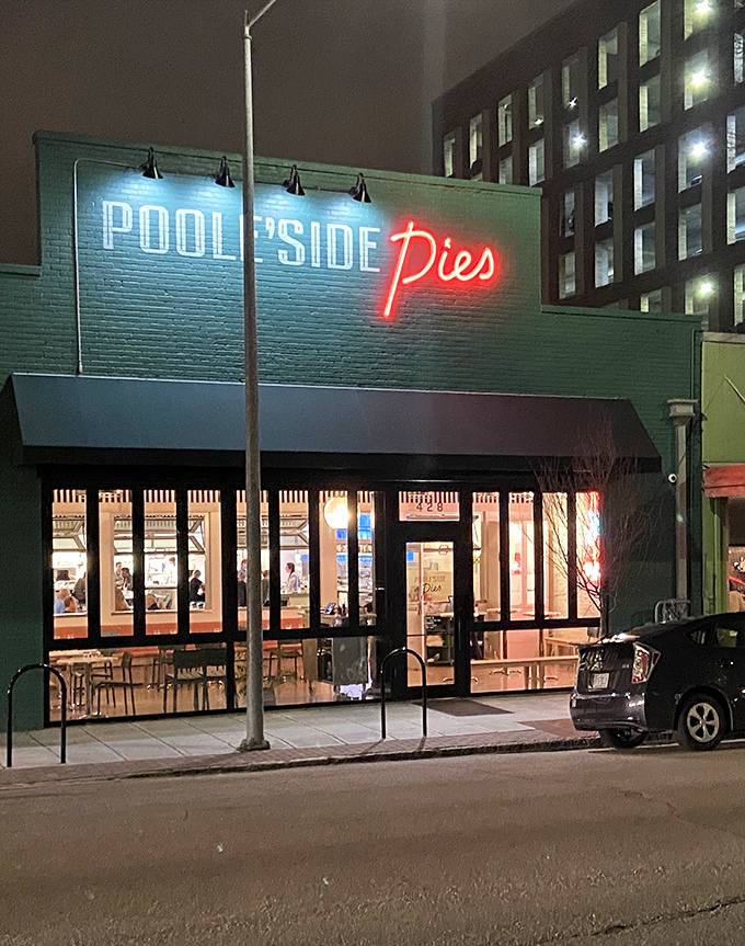 As night falls, the neon sign glows like a beacon for food lovers, drawing in hungry souls like moths to a delicious flame.
