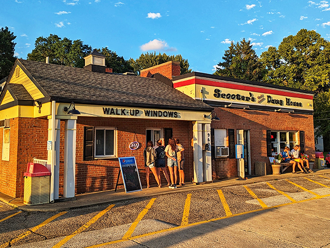 The golden hour glow on Scooter's walk-up windows beckons hungry visitors like a beacon of hope in a world of mediocre fast food.