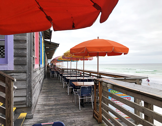 The covered deck offers protection from the elements without sacrificing that million-dollar Gulf view. Those colorful umbrellas are like exclamation points in a delicious story. 