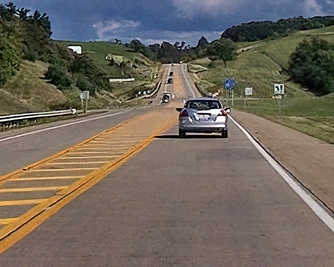The Amish Country Byway unfolds like a ribbon through rolling hills, where horse-drawn buggies often outnumber cars.