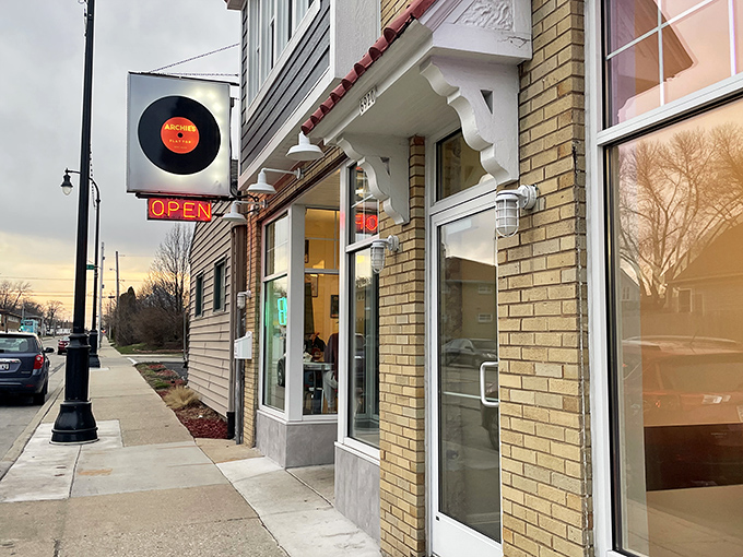 The vinyl record sign at Archie's Flat Top is a perfect prelude to the sizzling burger symphony waiting inside.