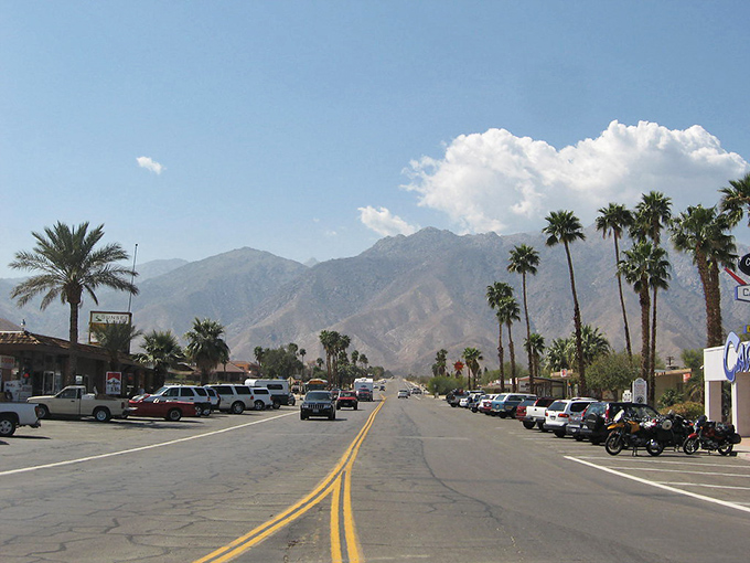 Palm trees stand guard along Borrego Springs' main street, with mountains creating a backdrop worthy of a postcard.
