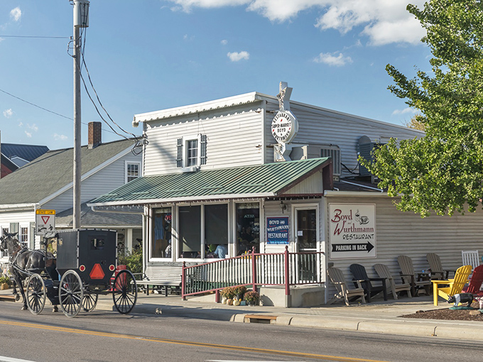 The classic white exterior with green trim and Amish buggies outside – this place screams authentic before you even taste the pie!