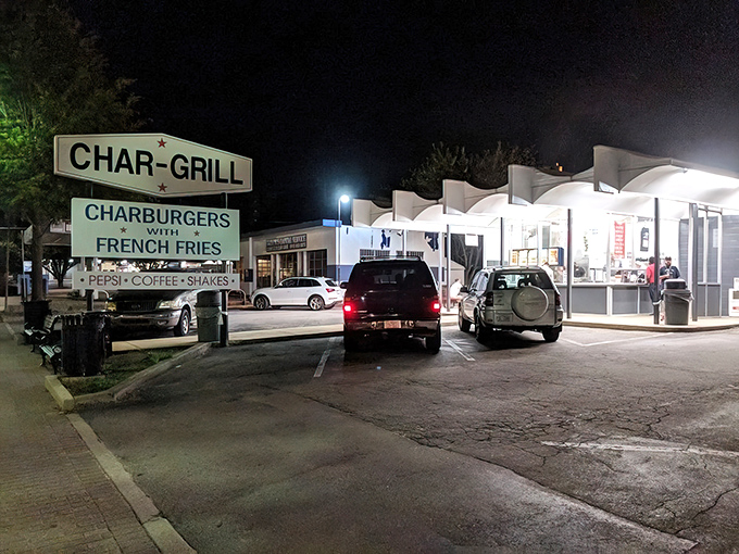 The iconic Char-Grill sign glows like a beacon in the night, promising charburgers that have kept Raleigh residents coming back for generations.