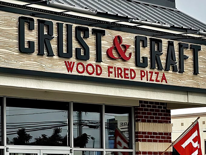 The rustic wooden sign at Crust & Craft promises wood-fired perfection. That ampersand isn't just punctuation&mdash;it's a delicious commitment.