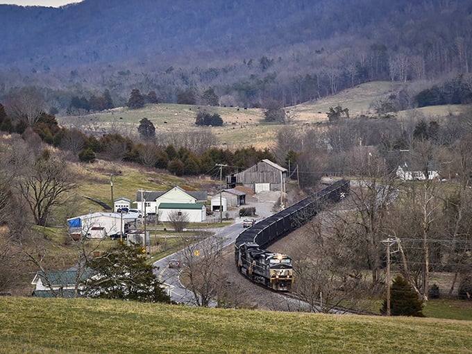 Rolling hills and railroad tracks create a perfect postcard scene where three states meet in mountain harmony.