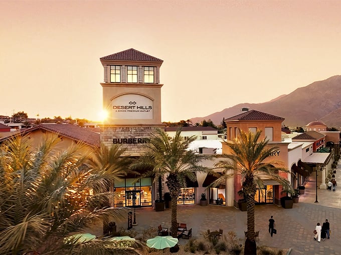 Desert Hills Premium Outlets at sunset &ndash; where bargain hunting meets vacation vibes under those swaying palm trees and golden skies.