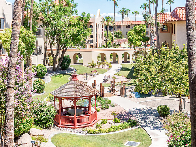 El Dorado's red gazebo stands like a cheerful sentinel among the palms. A perfect spot for morning coffee or evening chats with neighbors.