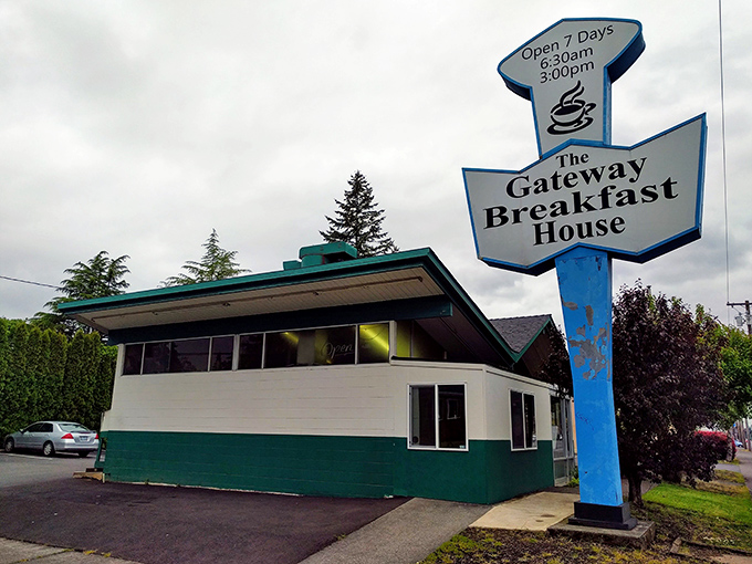 The iconic blue arrow sign of Gateway Breakfast House beckons like a neon lighthouse for hungry morning travelers.