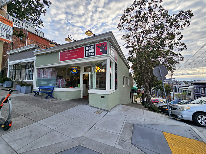 The mint-green storefront of Goat Hill Pizza beckons with its "OPEN" sign glowing like a beacon for sourdough-seeking San Franciscans.