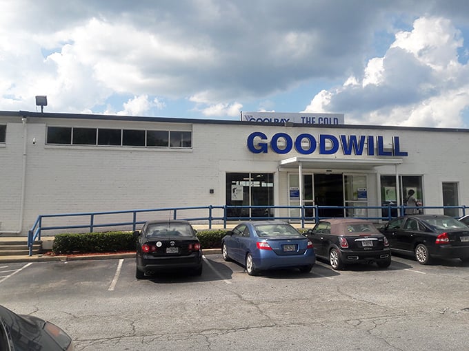 Those big blue letters promise adventure! Like a treasure chest disguised as a humble building, this thrift store awaits bargain hunters with open doors.