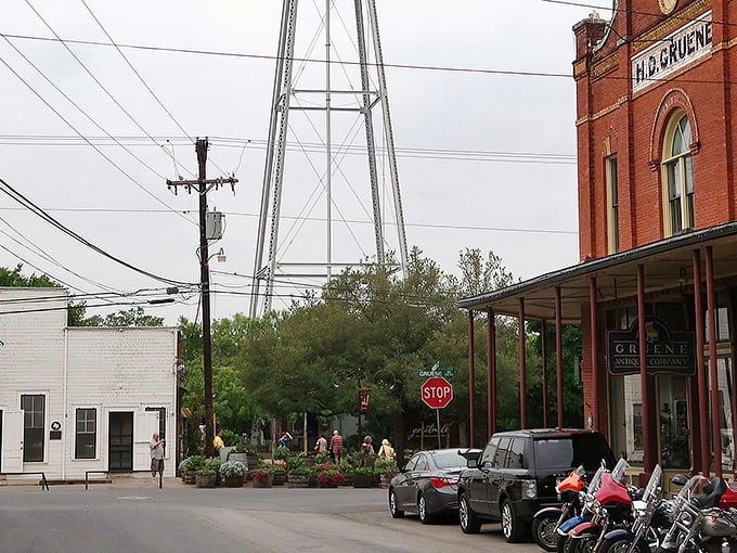Historic Gruene's red brick buildings and iconic water tower stand as sentinels of Texas past, where modern life politely waits its turn.