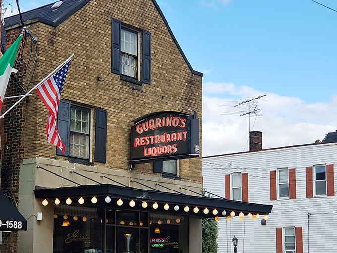 Guarino's brick facade with its vintage neon sign and string lights feels like a warm Italian hug in Cleveland's Little Italy.