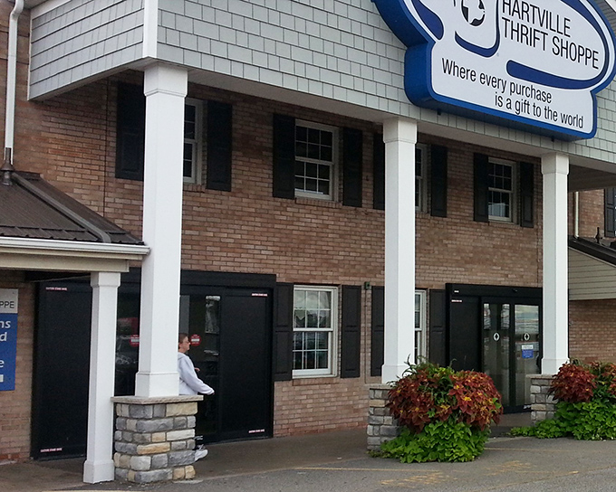 The welcoming brick facade of Hartville Thrift Shoppe promises treasure hunting adventures behind those black doors.