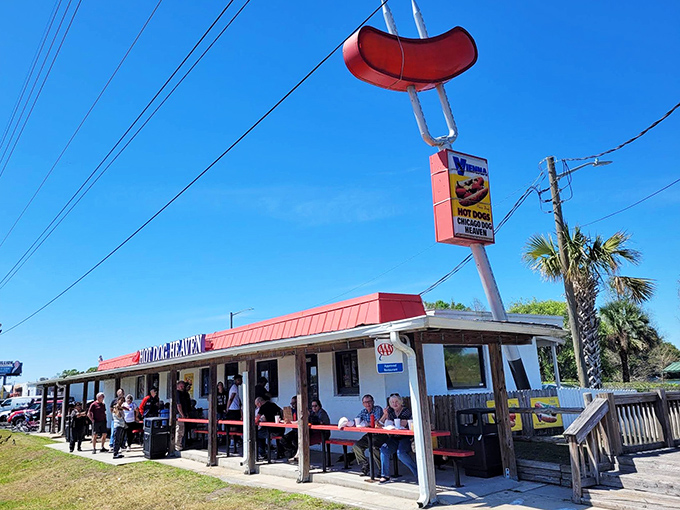 That giant hot dog sign isn't just advertising - it's a beacon calling all frankfurter faithful home.
