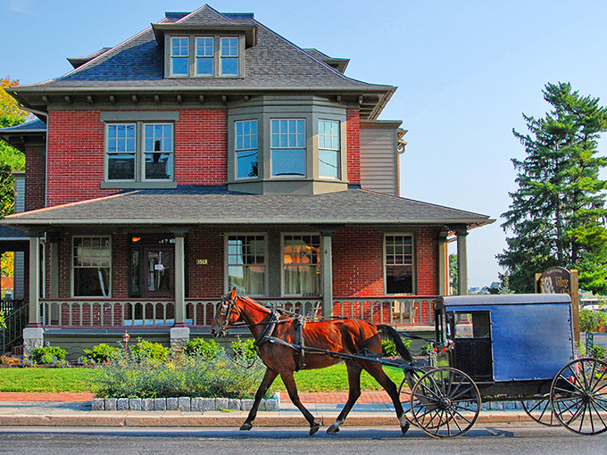 Horse and buggy cruise past a stately Victorian home - now that's what I call authentic street theater!