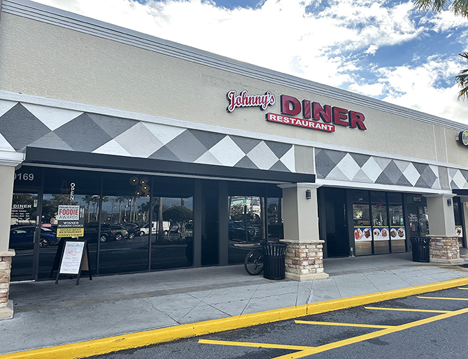 That checkered awning screams "classic diner" louder than a jukebox playing oldies at breakfast rush.