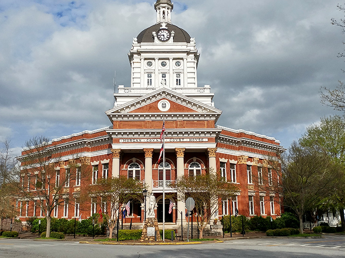 Madison's historic courthouse stands proud, a red-brick sentinel that's witnessed generations of Georgia history unfold beneath its stately clock tower.