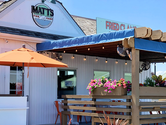 Matt's Fish Camp exterior beckons with its blue awning and "Fried Clams" sign &ndash; a humble facade hiding seafood treasures that would make Neptune jealous.