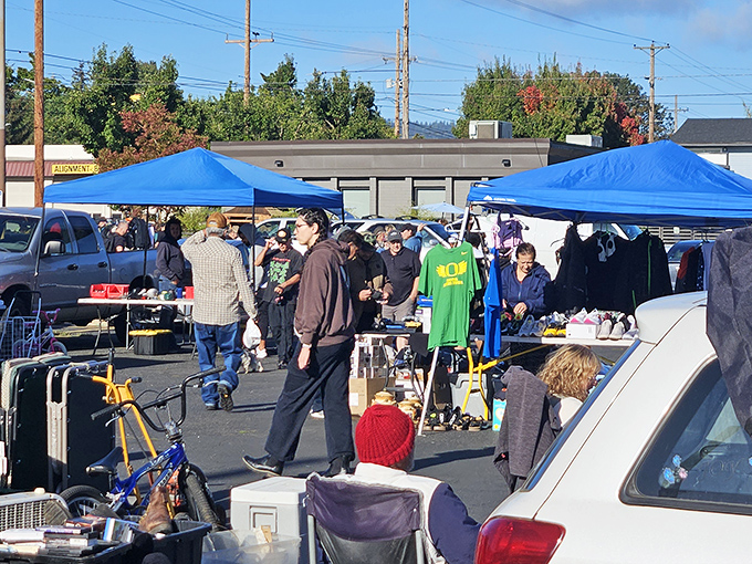 Treasure hunters navigate a sea of blue canopies at North Portland Flea Market, where one person's castoffs become another's prized possessions.