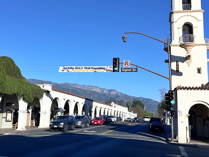 Ojai's Spanish-style arcade welcomes visitors with its distinctive white buildings and red-tiled roofs. Mountains stand guard in the background like protective giants.