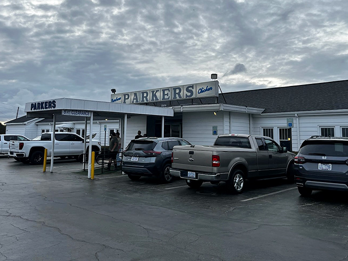 Parker's Barbecue stands proud in Wilson, a white-walled temple of pork that's been drawing crowds for generations. The full parking lot tells you everything you need to know!