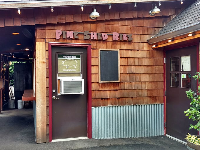 The rustic wooden exterior of Pine Shed Ribs looks like a secret clubhouse where the password is "brisket." Smoky treasures await inside!