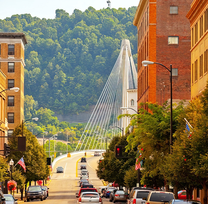 Portsmouth's iconic suspension bridge stretches gracefully across the Ohio River, connecting two states while framing the city's historic brick buildings.