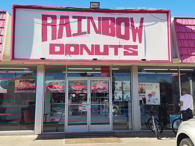 The iconic pink sign of Rainbow Donuts beckons like a sugary lighthouse in the Phoenix morning. Sweet promises await inside!