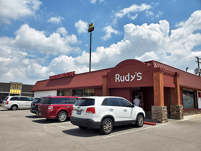 Rudy's Smokehouse exterior beckons with its bold red roof &ndash; like a barbecue lighthouse guiding hungry souls to smoky paradise.