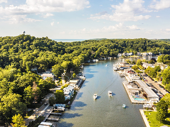 Saugatuck: Aerial paradise where the Kalamazoo River meets Lake Michigan &ndash; nature's perfect marriage of blue waters and lush greenery.