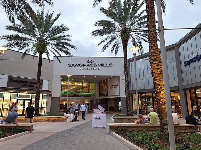 The grand entrance to Sawgrass Mills, where palm trees stand like shopping sentinels welcoming you to Florida's retail paradise.