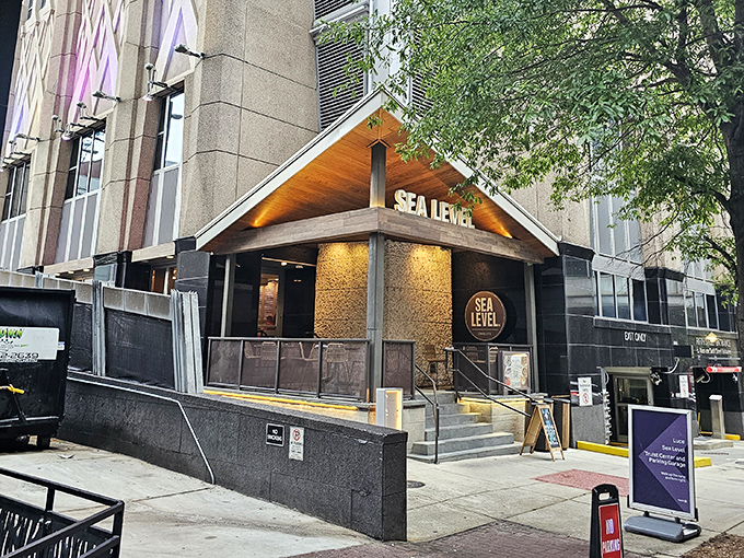Sea Level NC's sleek wooden entrance beckons like a lighthouse for seafood lovers lost in the concrete jungle of Charlotte.