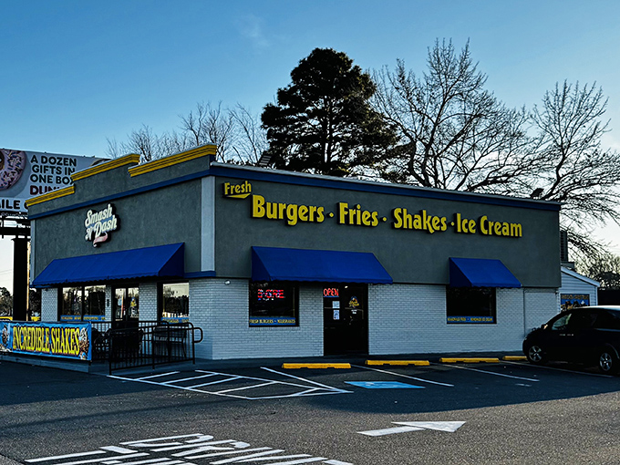 That blue awning beckons like a beacon for burger lovers seeking smash-grilled perfection. 