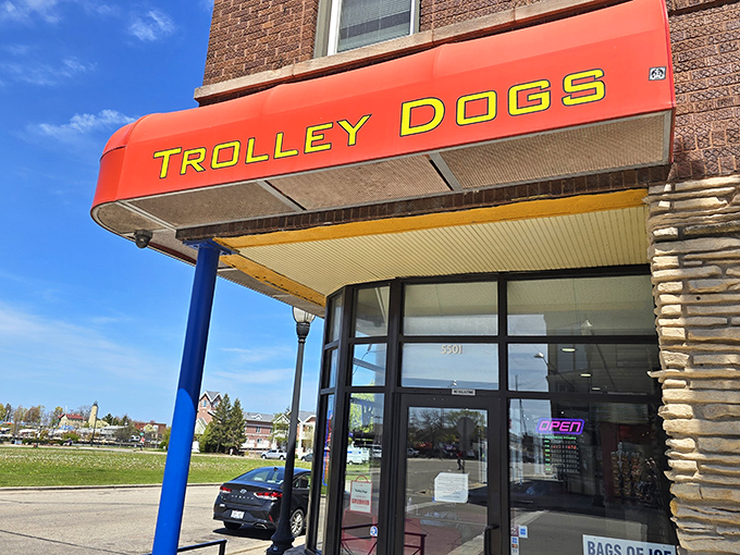 The bright red "TROLLEY DOGS" sign beckons like a lighthouse for the hungry. This Kenosha landmark promises hot dog heaven just steps away.