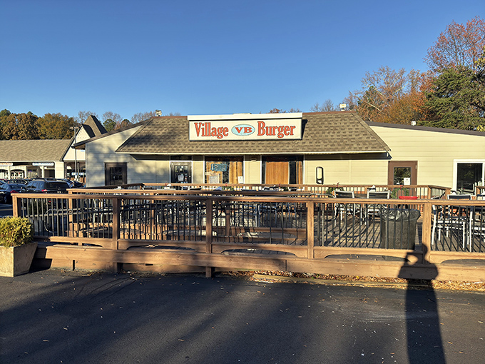 Village Burger's welcoming storefront promises burger paradise. That wooden deck practically begs you to sit and savor every juicy bite.