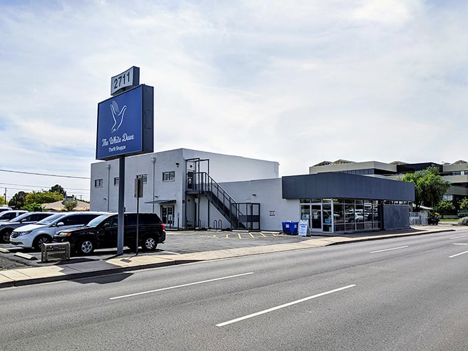 The White Dove Thrift Shoppe's blue sign beckons bargain hunters like a lighthouse for the frugally fashionable.
