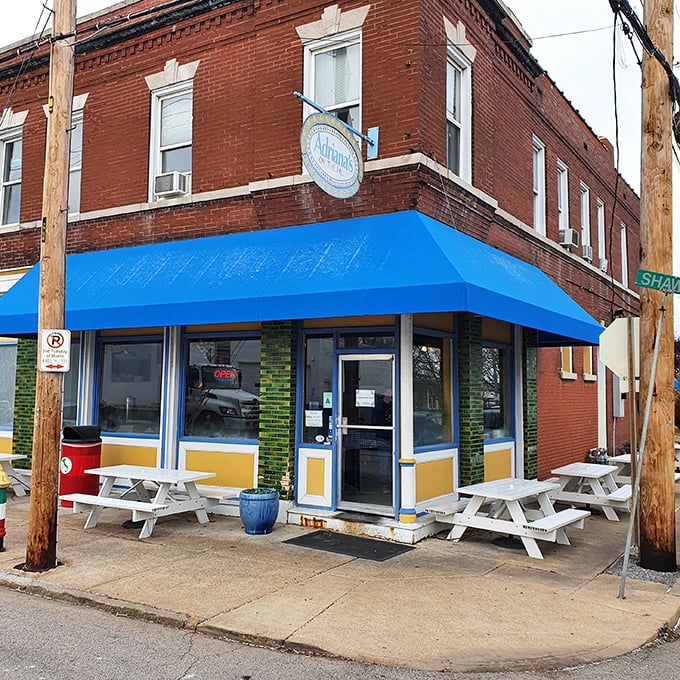 White picnic tables outside Adriana's blue-awninged storefront &ndash; where sandwich dreams come true and diet plans go to die.