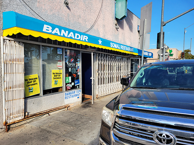 Security gates by day, Somali flavor paradise by night. This humble spot serves goat meat that will haunt your dreams.