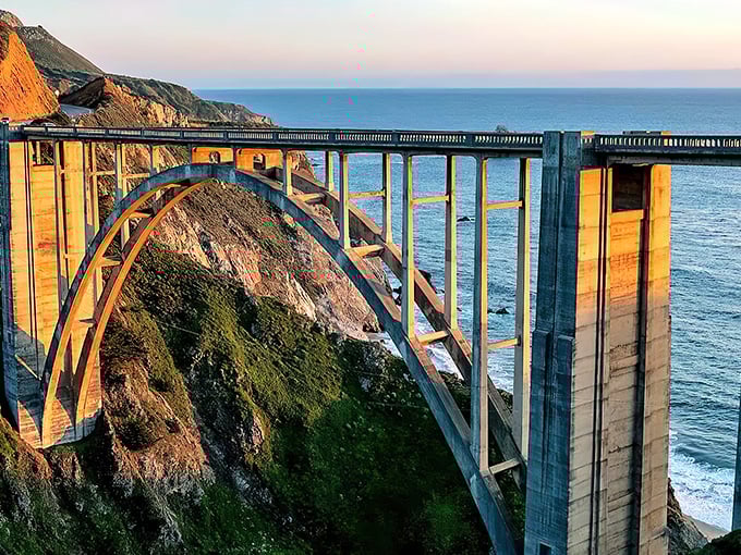 Engineering marvel meets natural wonder. The iconic arch of Bixby Bridge frames the rugged Big Sur coastline like a perfect postcard come to life.
