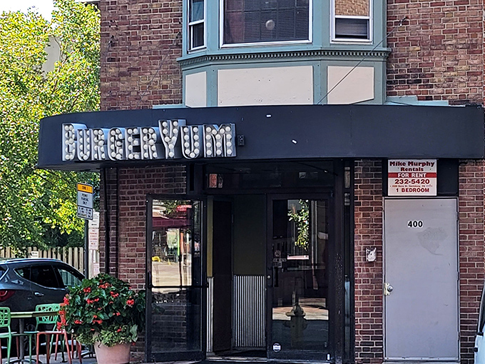 Sunshine highlights Burger Yum's marquee sign, a straightforward name that makes a delicious promise it absolutely keeps.