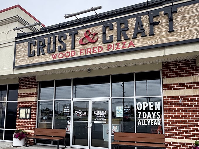 Open seven days a year? No, ALL year! Crust & Craft's welcoming storefront beckons pizza lovers with its brick-and-wood charm.