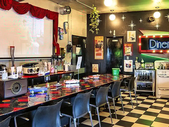 Step inside this retro wonderland where vinyl records meet classic diner vibes. The black and white floor practically screams "breakfast time!"